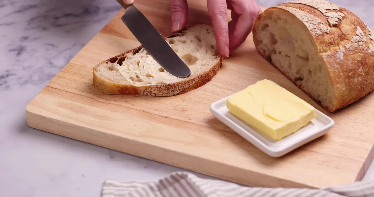 Butter Being Spread on Bread