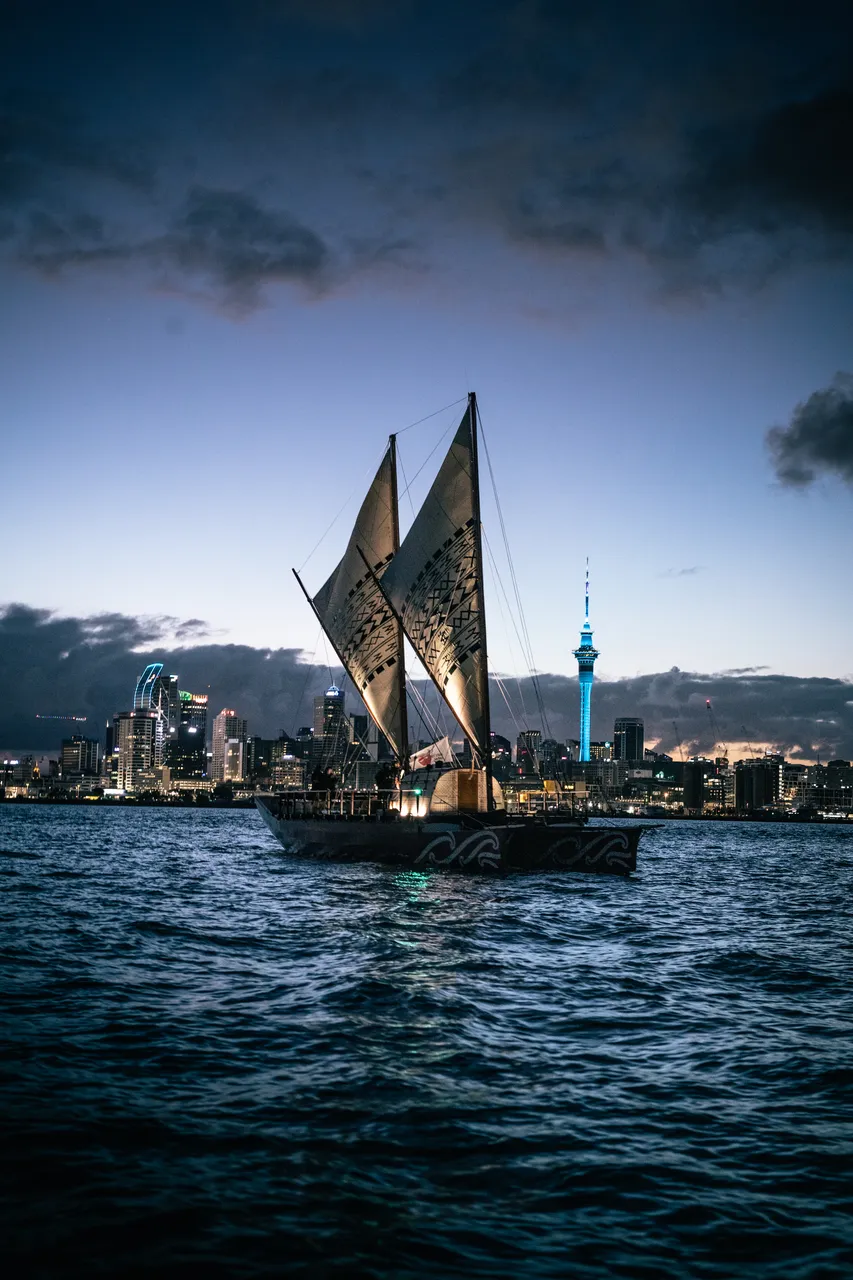 Waka Hourua sailing The Waitematā Harbour with Sky Tower in the background