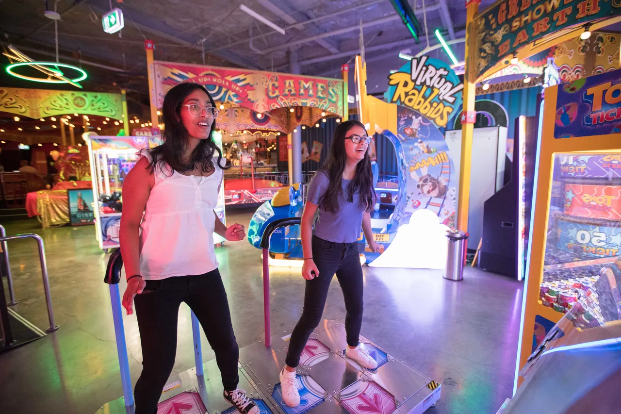 Students playing at arcade